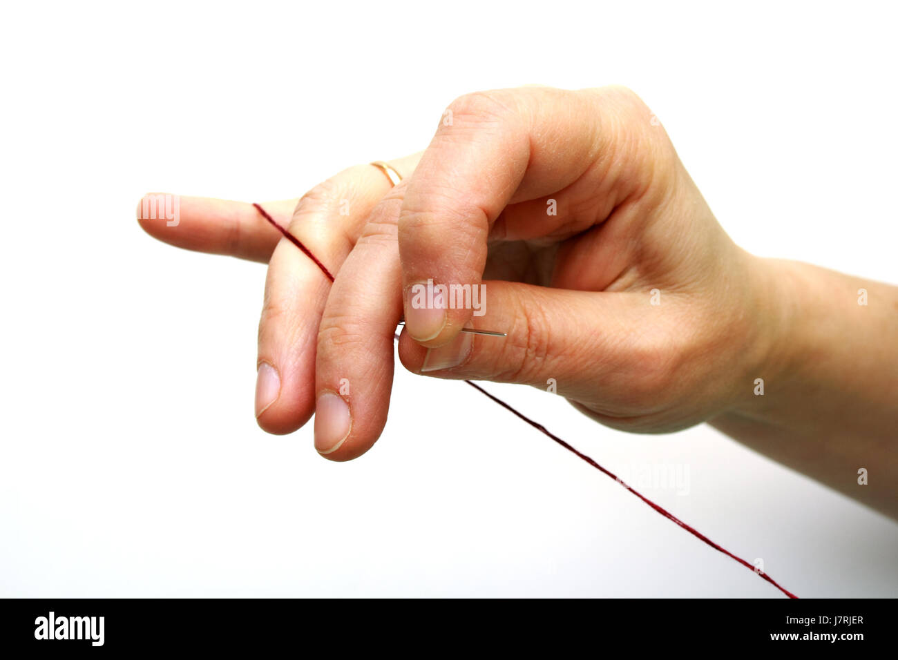 thread needle sewing and woman women finger tool object macro close-up ...