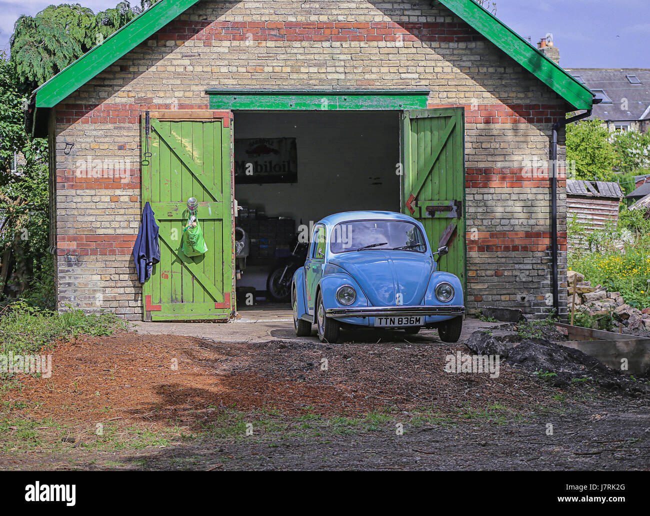 VW Beetle Parked In Front Of The Garage Stock Photo - Alamy