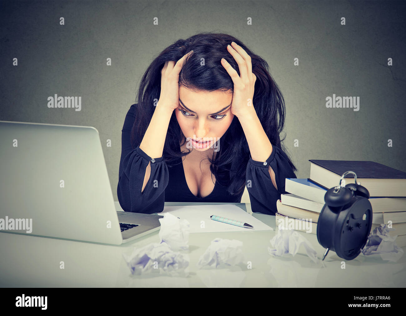 Too much work stressed woman sitting at her desk with books in front of ...