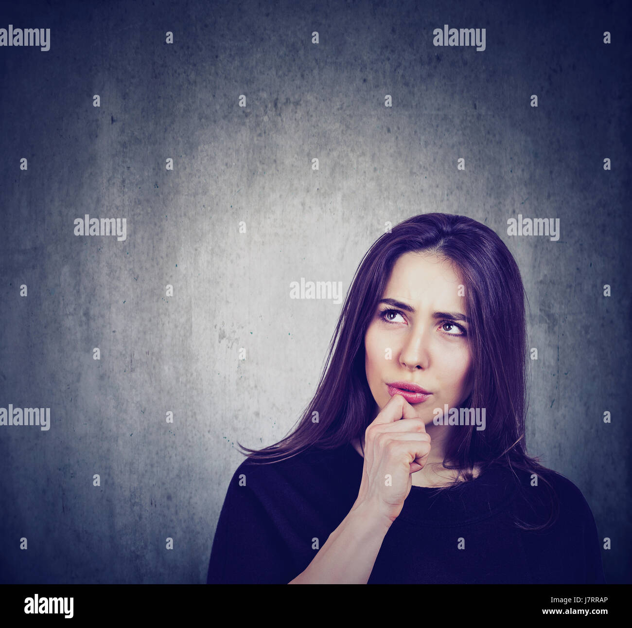 pensive thoughtful woman on a blackboard background Stock Photo - Alamy