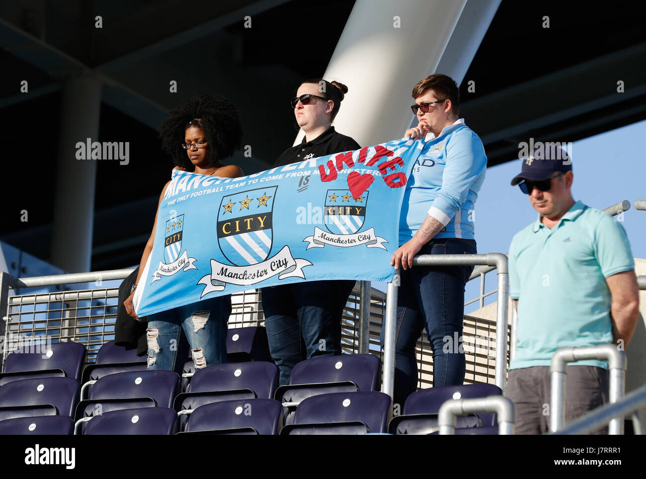 Manchester City fans with a banner in memory of the victims of the ...