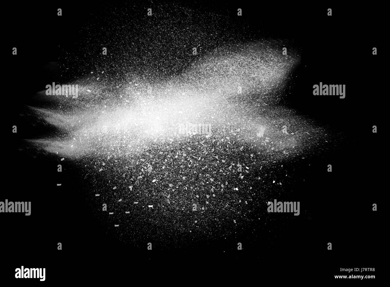 Freeze motion of white powder exploding, isolated on black, dark ...