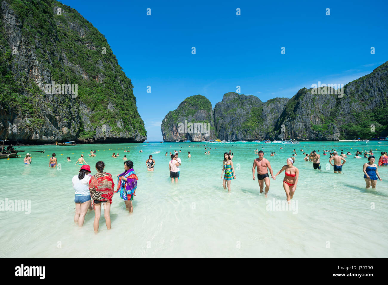 MAYA BAY, THAILAND - NOVEMBER 12, 2014: Crowds of sunbathing visitors ...