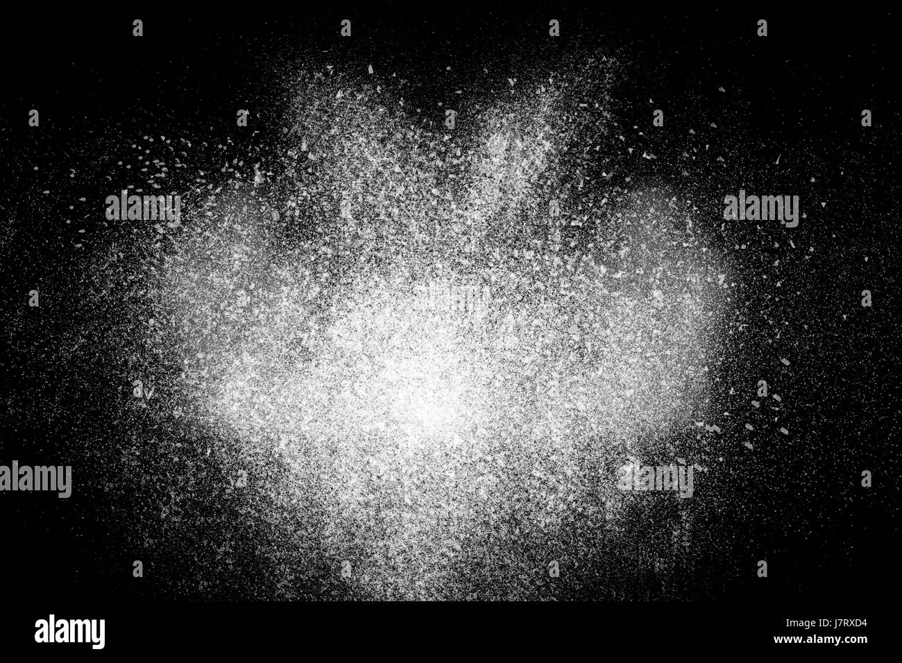 Freeze motion of white powder exploding, isolated on black, dark ...