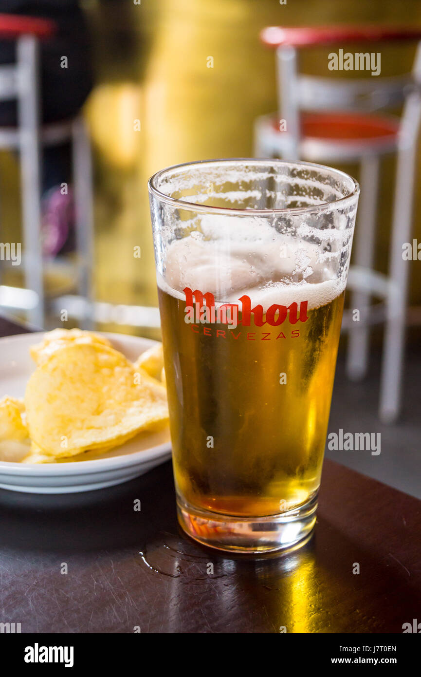 A printed glass of Mahou Spanish lager beer on a bar, Oviedo, Asturias ...