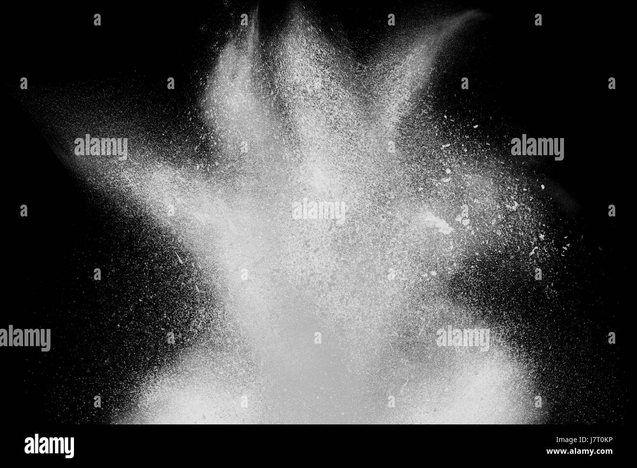 Freeze motion of white powder exploding, isolated on black, dark ...