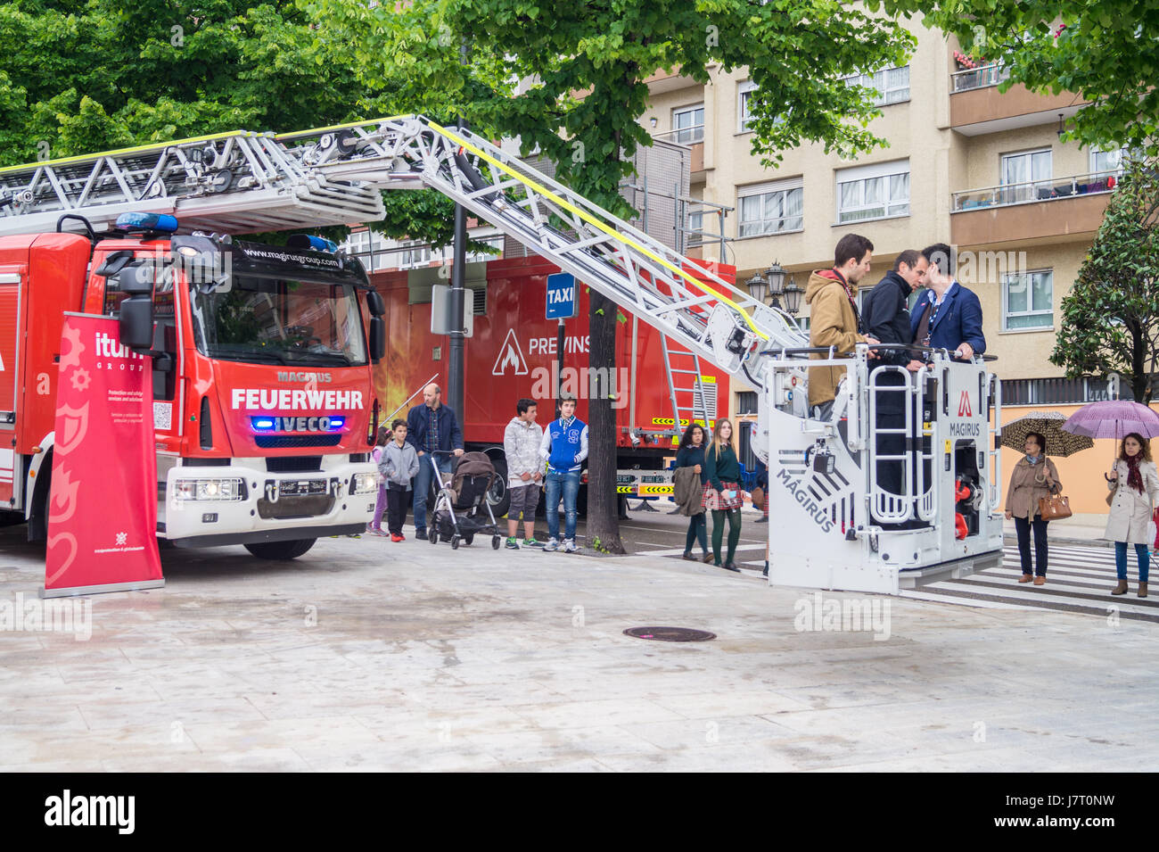 Journalists riding on a Magirus M68L turntable ladder at a fire service ...