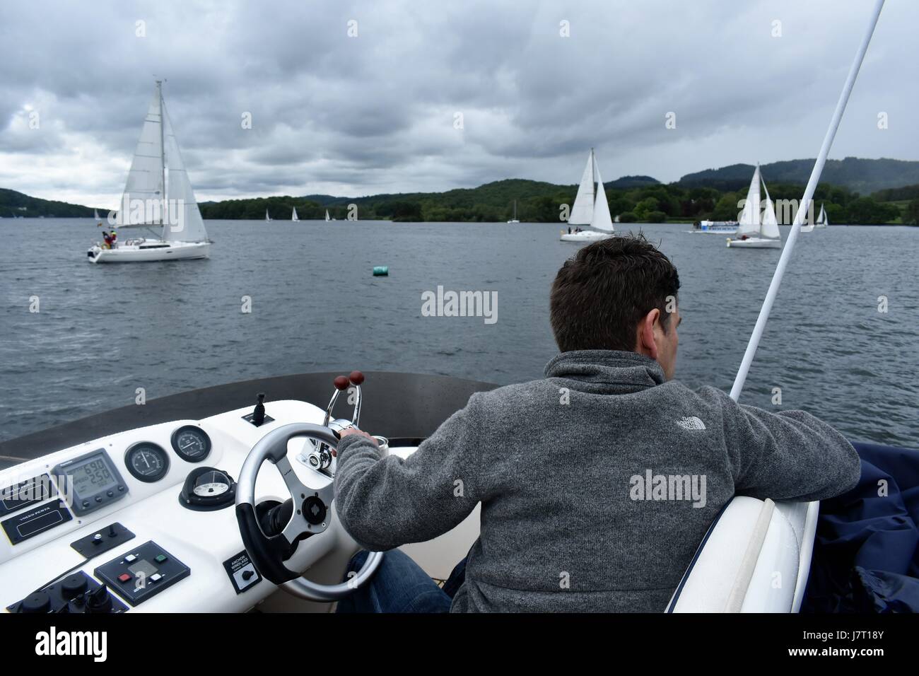 A man on a motor boat Lake Windermere Stock Photo - Alamy