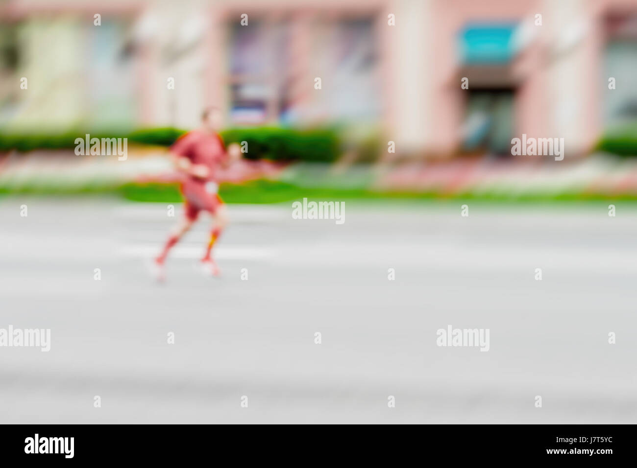 Runner athlete running on the street, city marathon, blur effect ...
