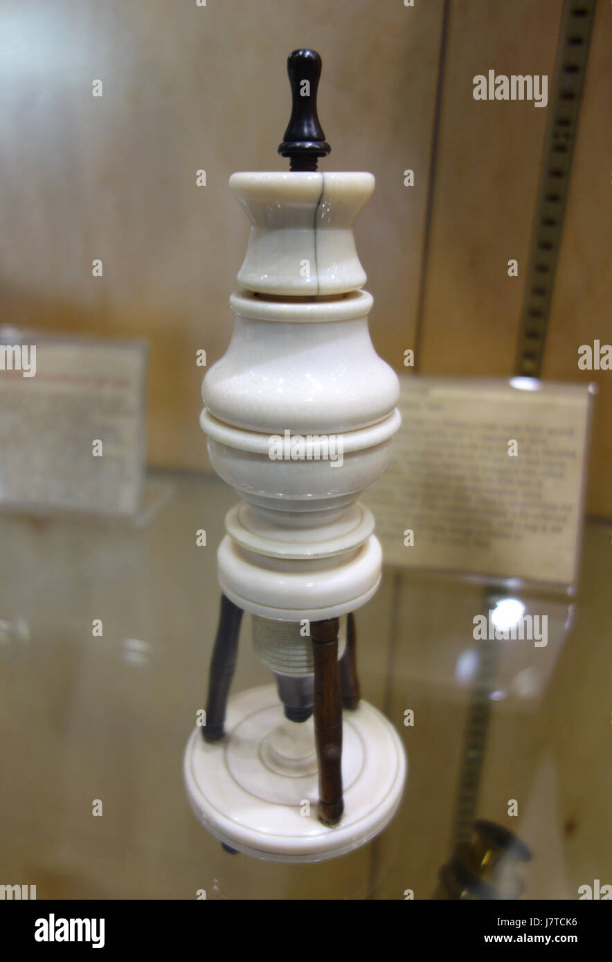 A circa 1660 ivory compound microscope mounted on mahogany pillars ...