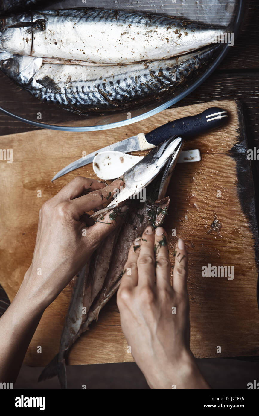 Woman preparing mackerel fish Stock Photo - Alamy