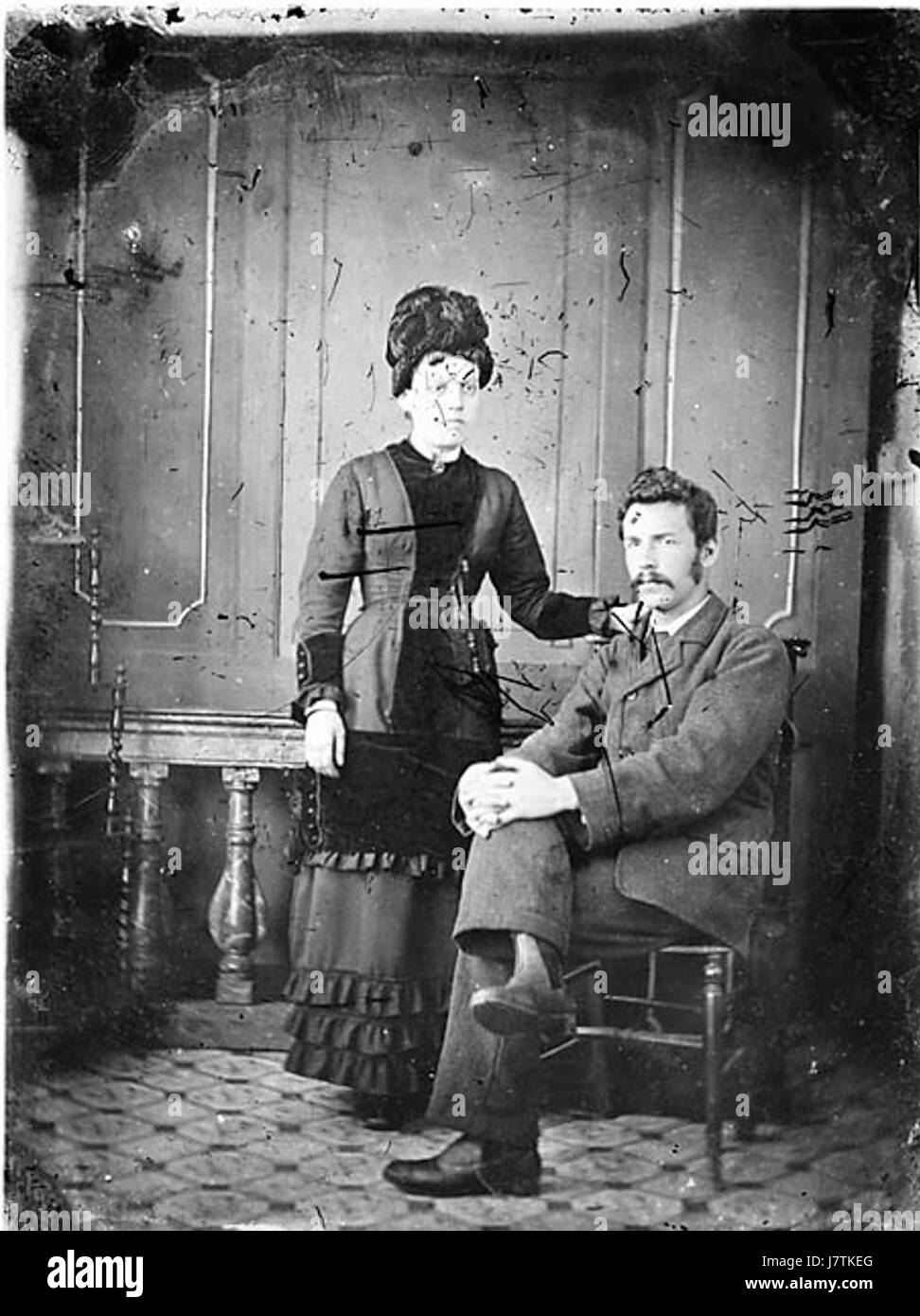 This photograph captures a woman and a man in an intimate, reflective ...