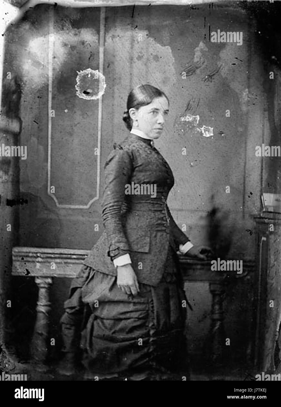 This photograph features a woman standing, capturing a moment of ...