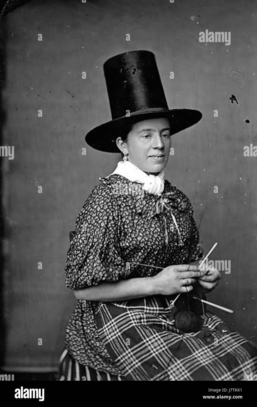 A portrait of a woman in traditional national dress, engaged in ...