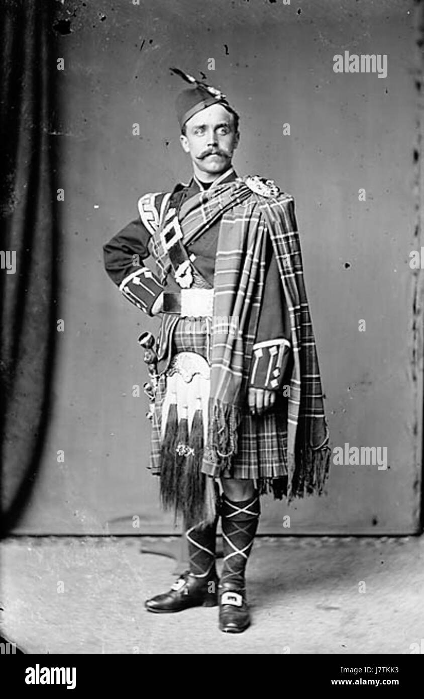 This photograph shows a man dressed in traditional tartan attire ...
