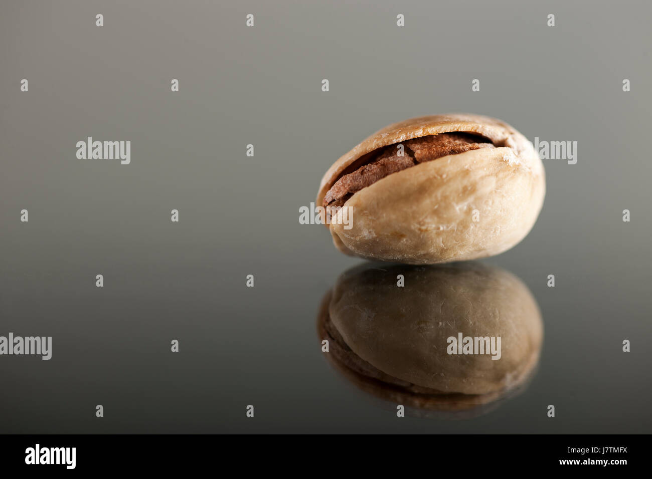 Single pistachio on a glass plate Stock Photo - Alamy