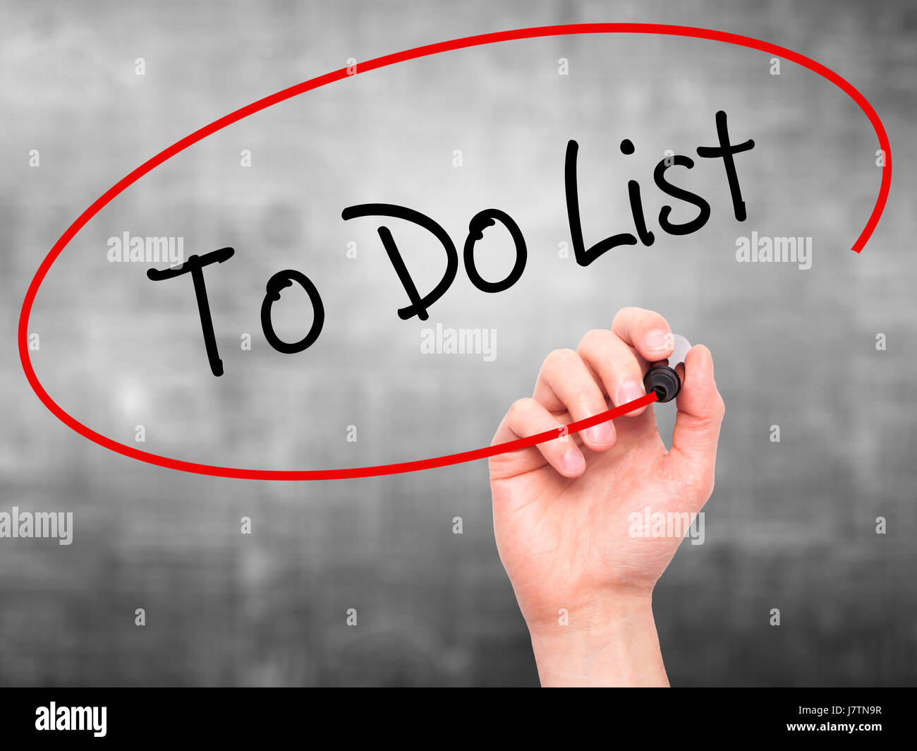 Man Hand writing To Do List with black marker on visual screen ...