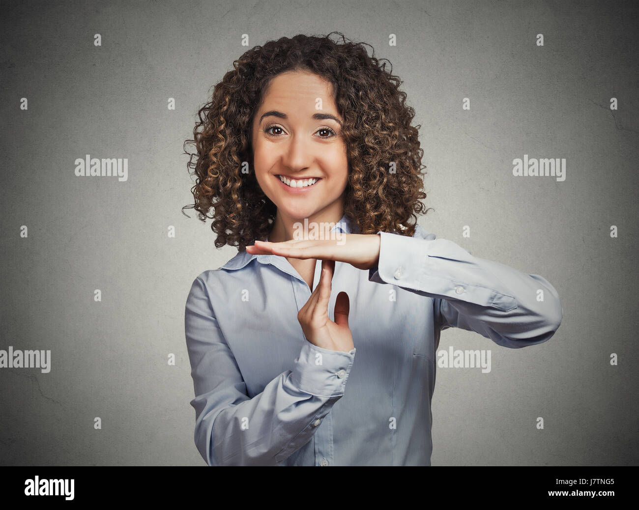 Closeup portrait young happy, smiling woman showing time out gesture ...