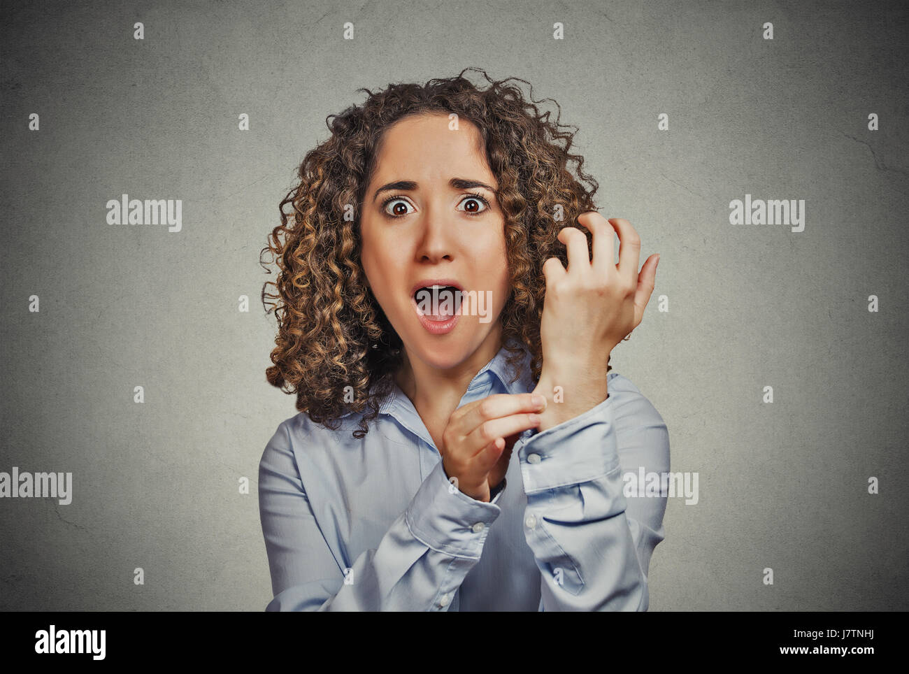 Reality check gesture. Portrait surprised woman pinching her arm skin ...