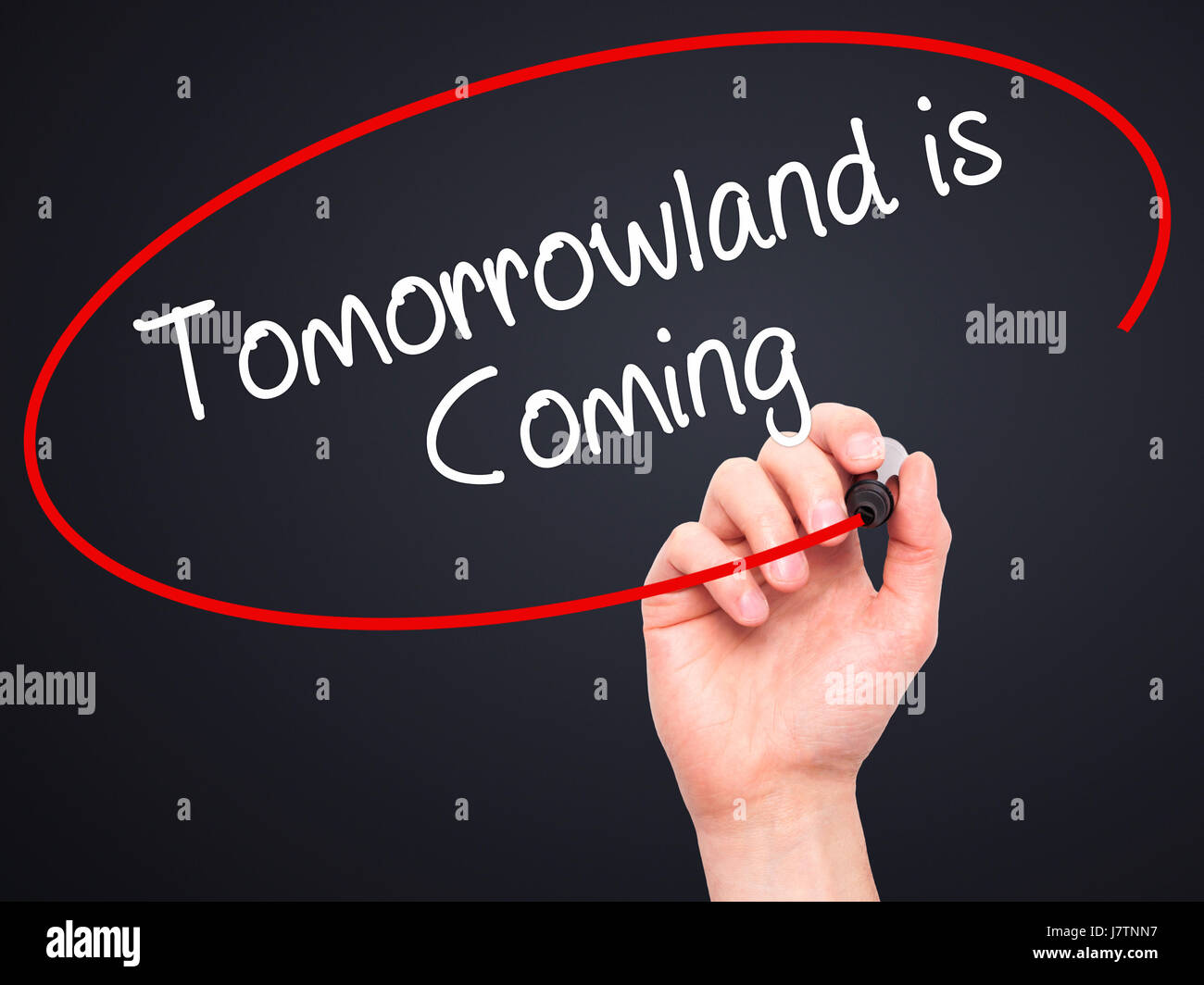 Man Hand writing Tomorrowland is Coming with black marker on visual ...