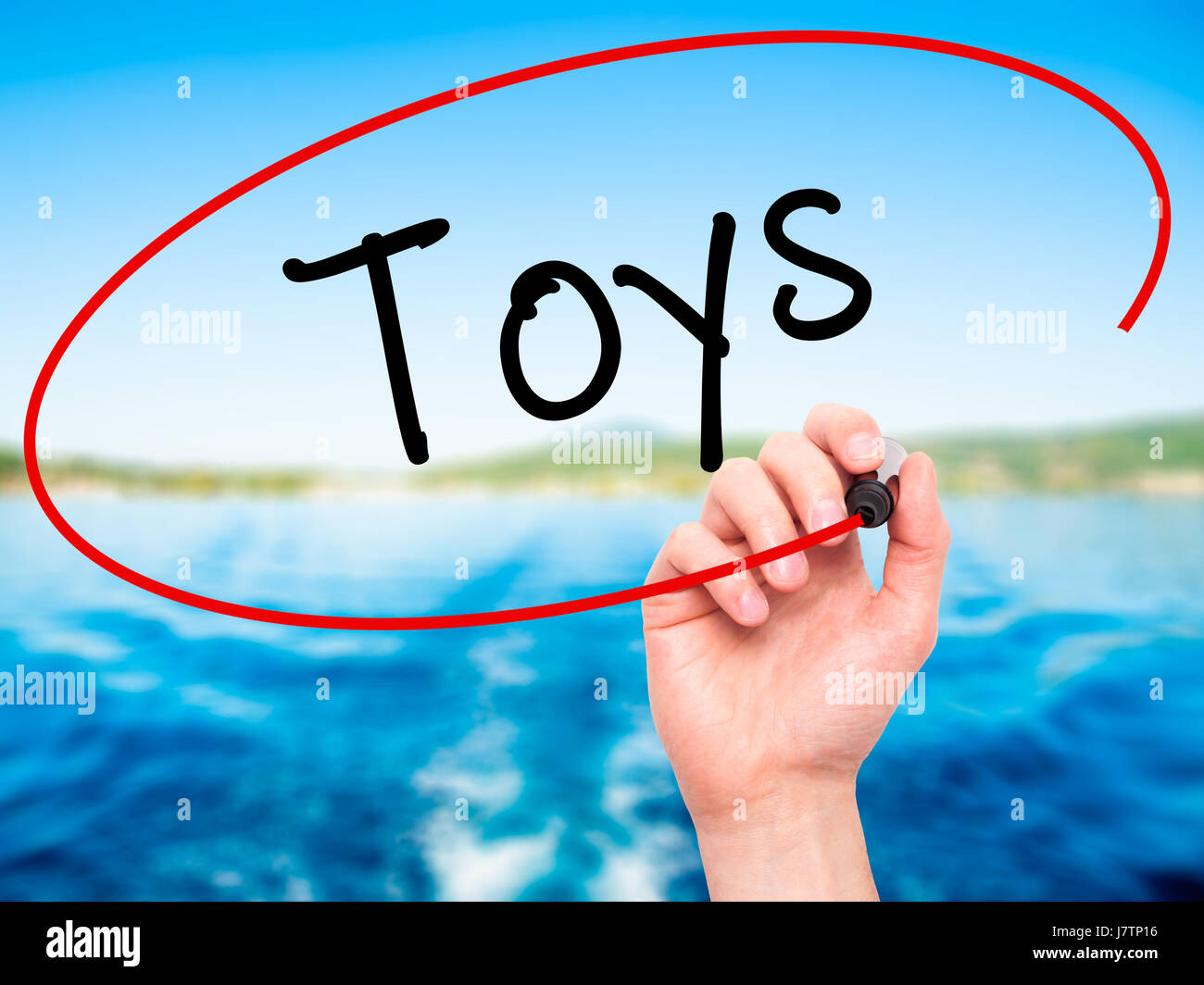 Man Hand writing Toys with black marker on visual screen. Isolated on ...