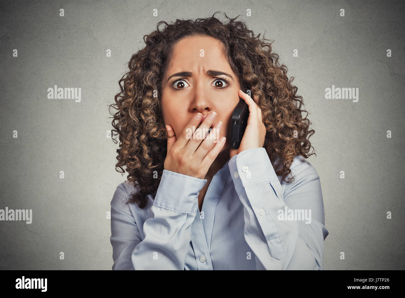 Headshot shocked stunned young woman getting bad news while talking on ...