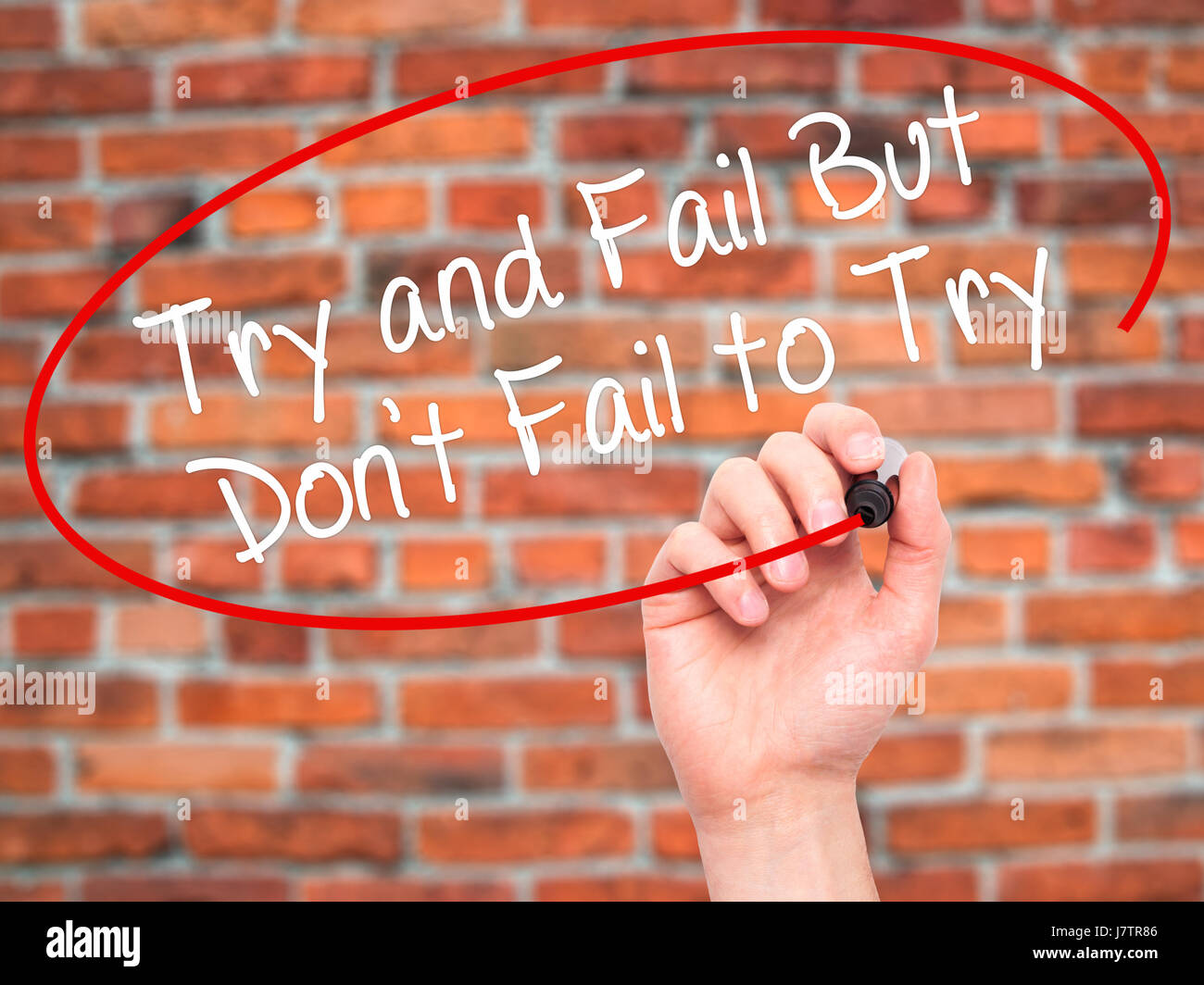 Man Hand writing Try and Fail But Don't Fail to Try with black marker ...