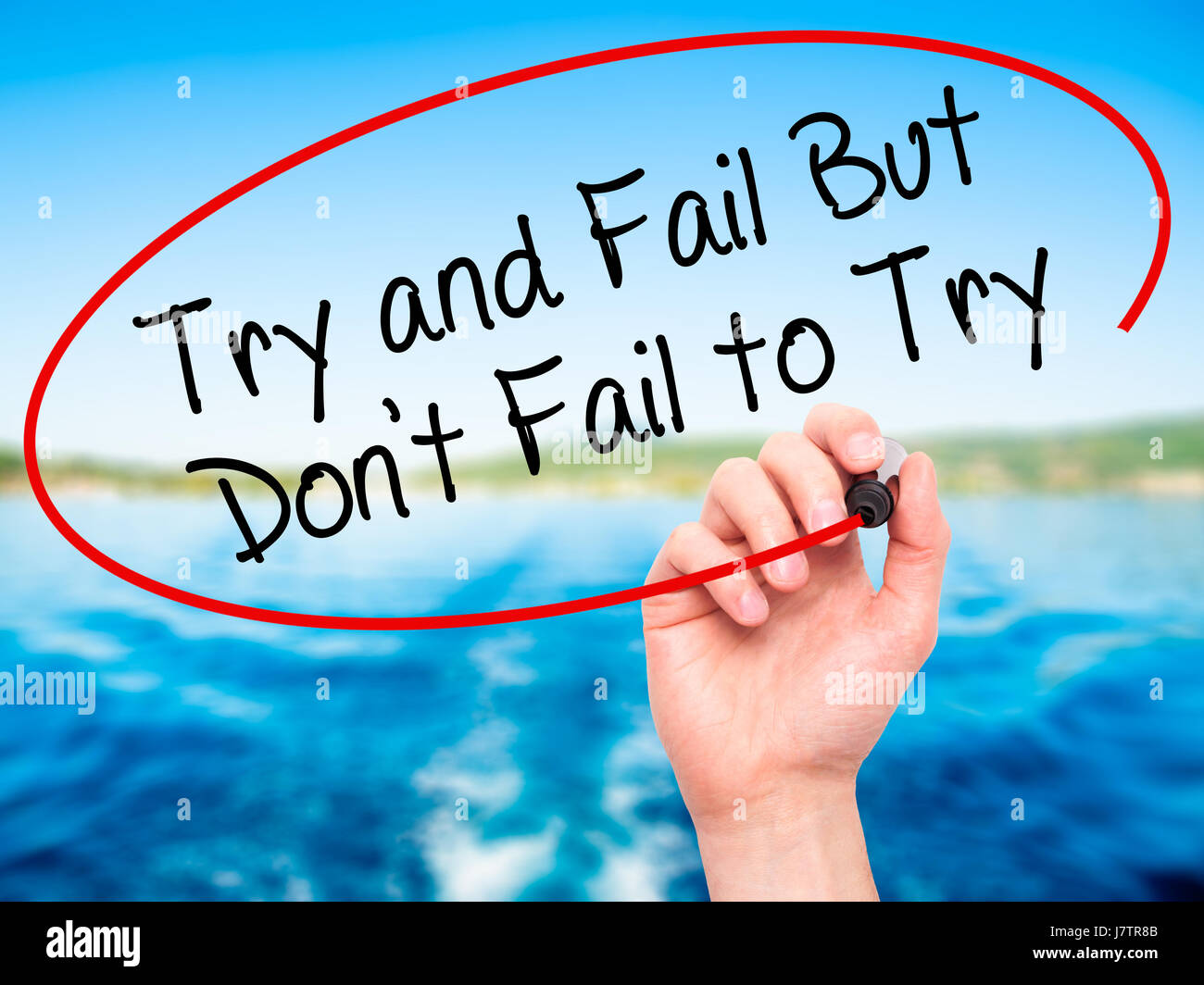 Man Hand writing Try and Fail But Don't Fail to Try with black marker ...