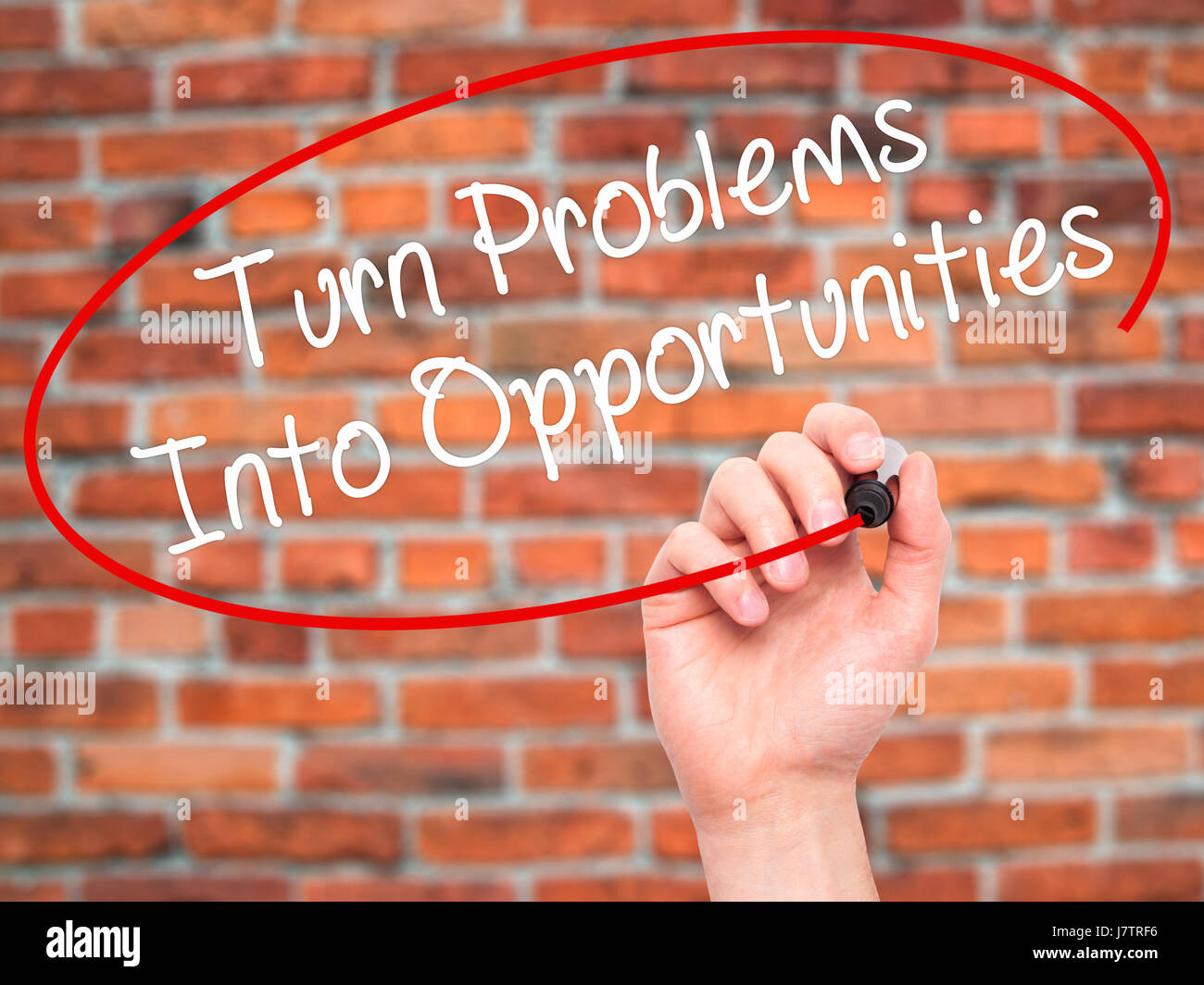 Man Hand writing Turn Problems into Opportunities with black marker on ...