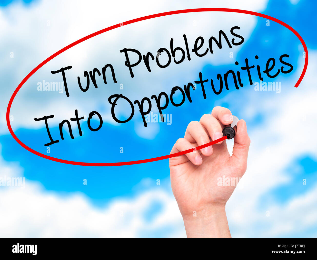 Man Hand writing Turn Problems into Opportunities with black marker on ...