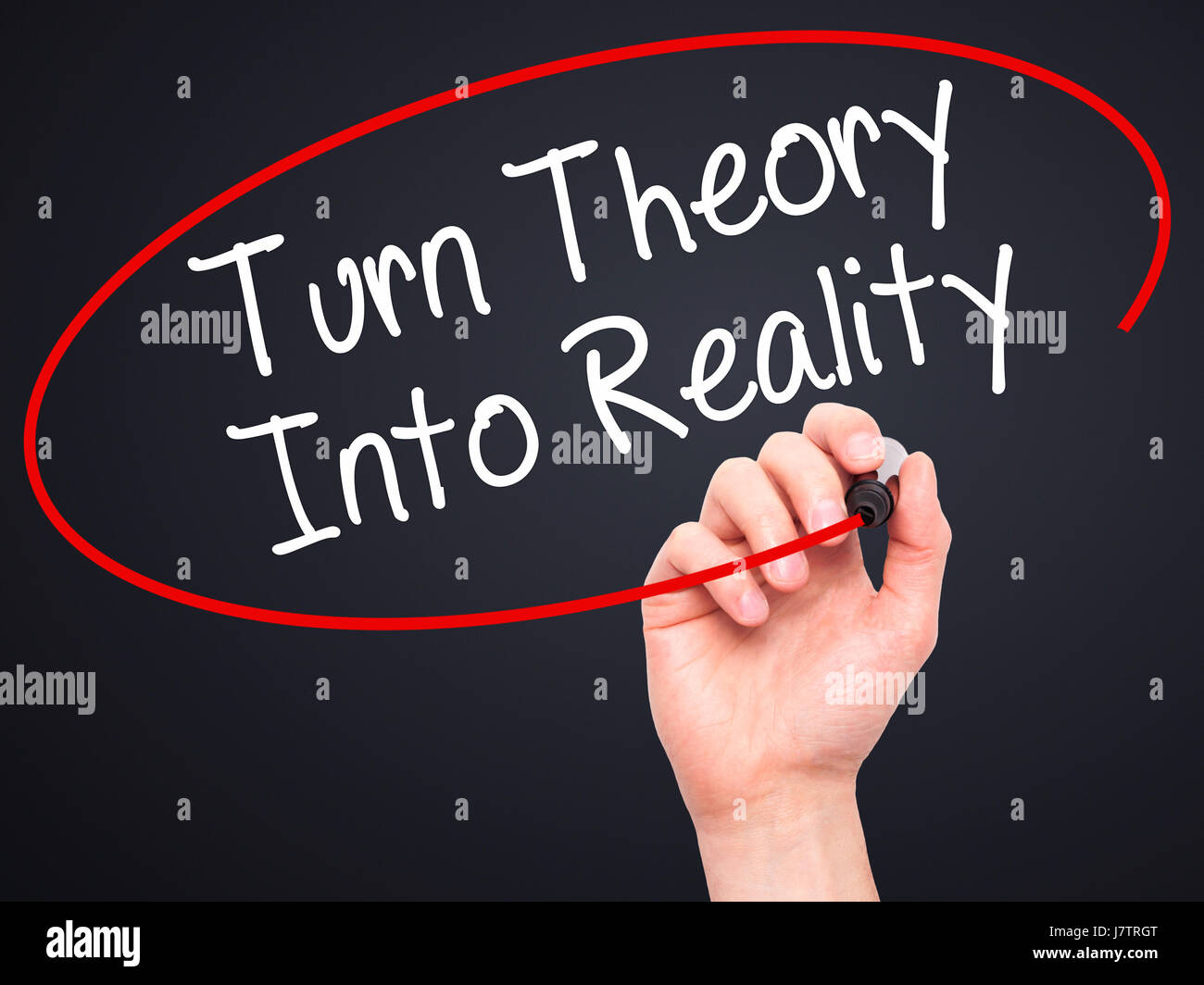Man Hand writing Turn Theory Into Reality with black marker on visual ...