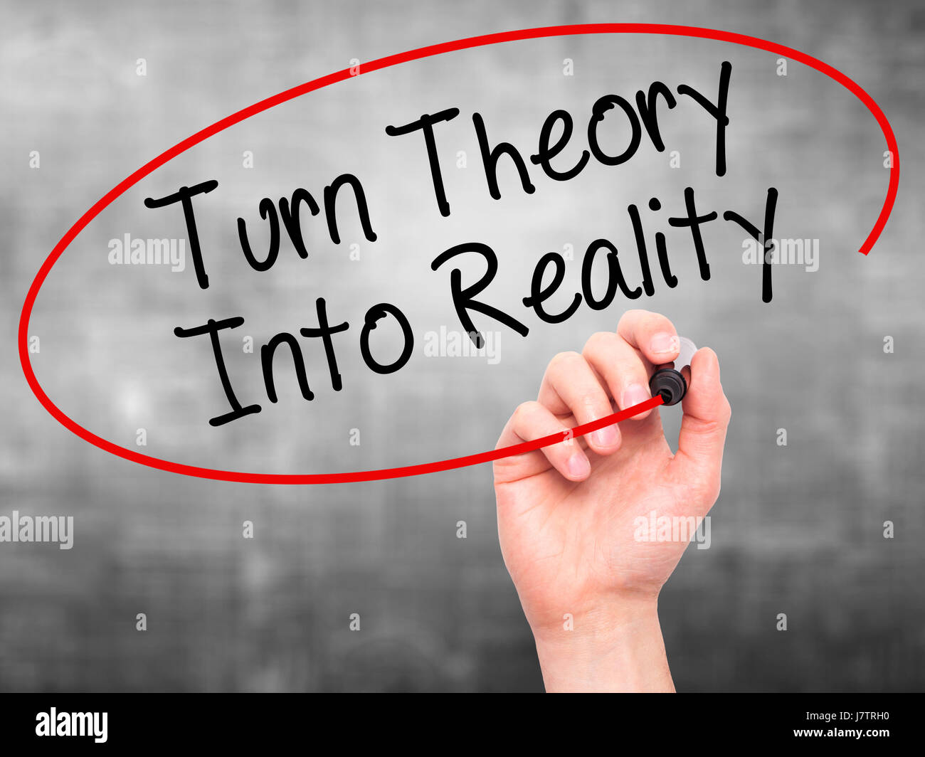 Man Hand writing Turn Theory Into Reality with black marker on visual ...