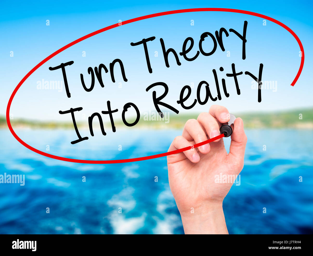 Man Hand writing Turn Theory Into Reality with black marker on visual ...