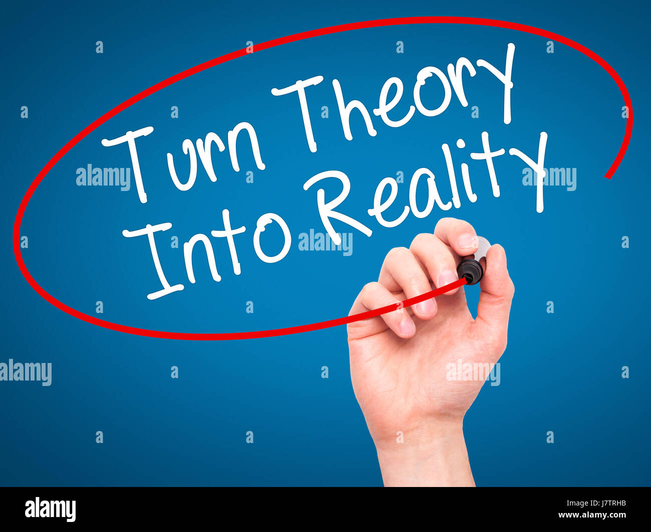 Man Hand writing Turn Theory Into Reality with black marker on visual ...