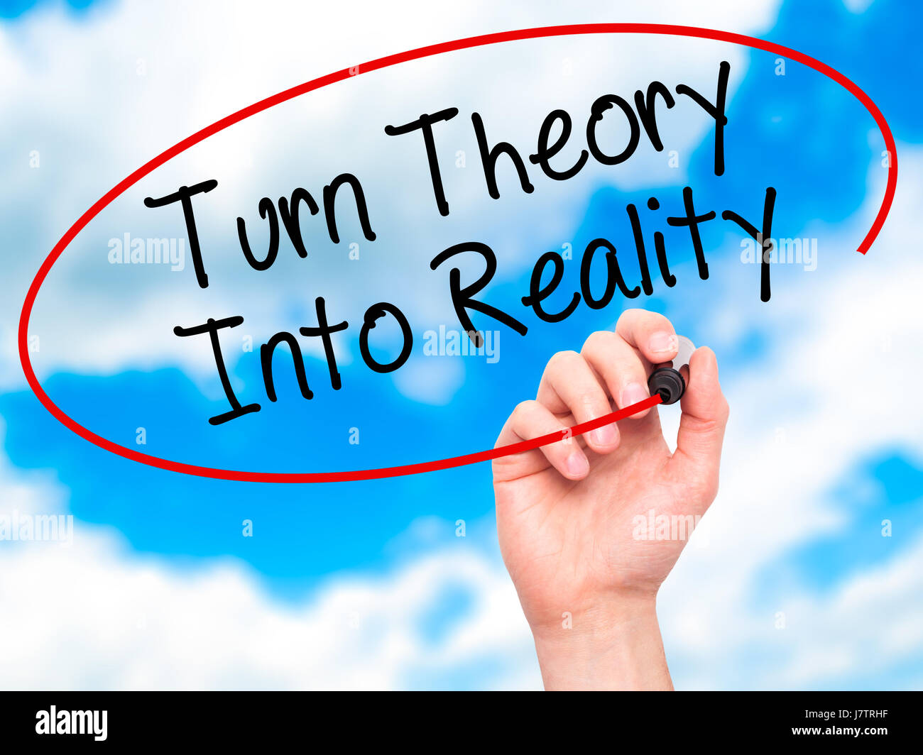 Man Hand writing Turn Theory Into Reality with black marker on visual ...