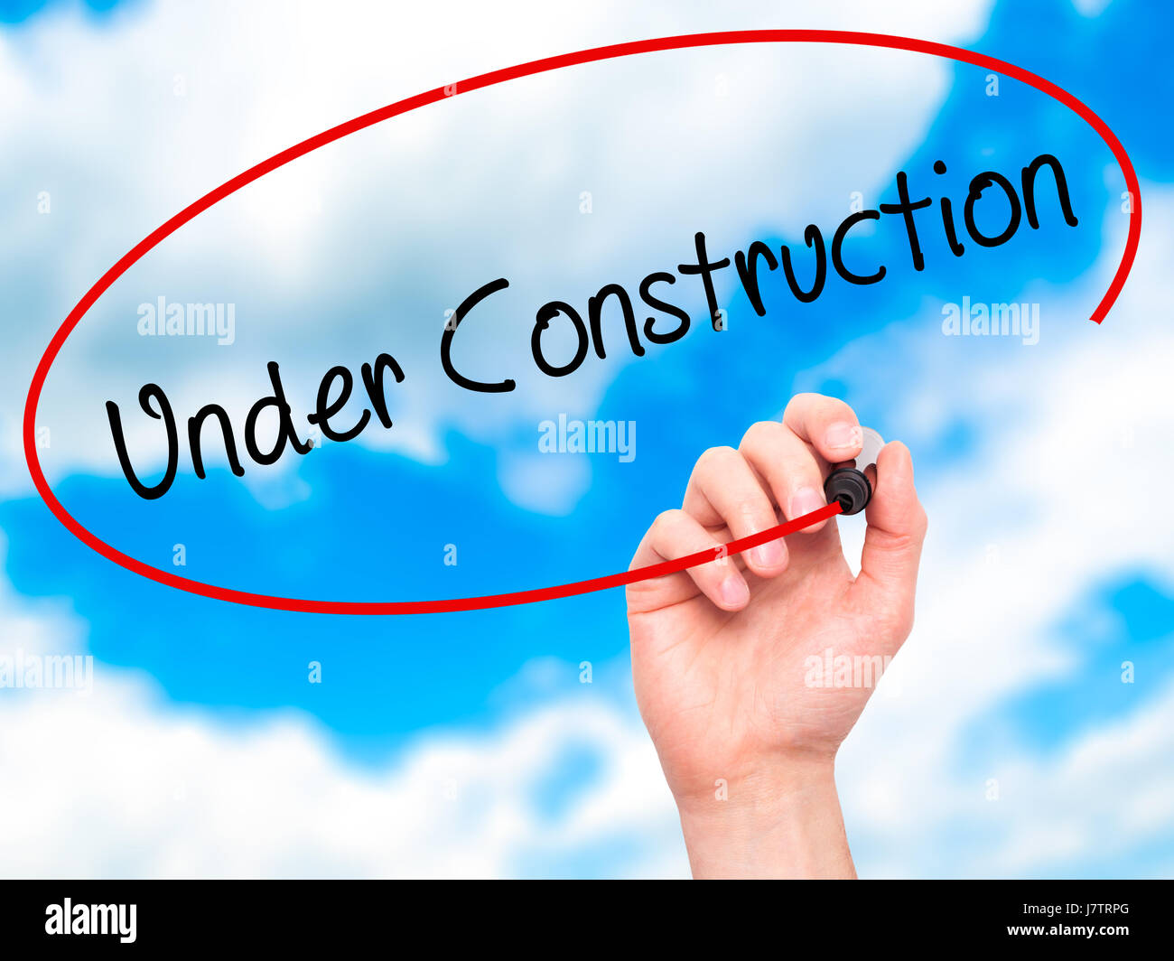 Man Hand writing Under Construction with black marker on visual screen ...