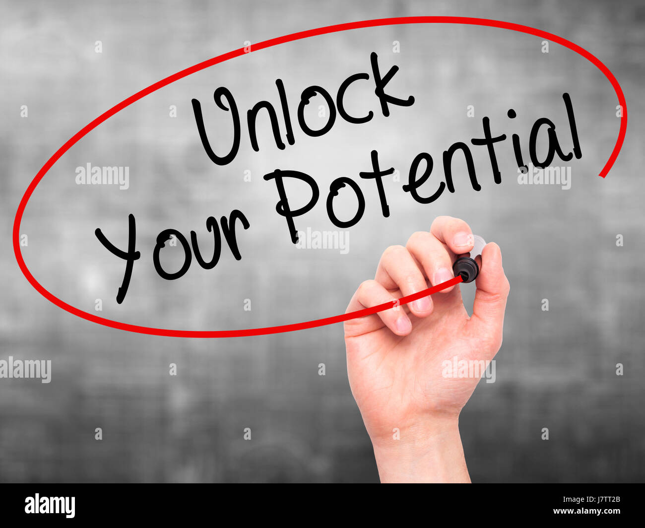 Man Hand writing Unlock Your Potential with black marker on visual ...