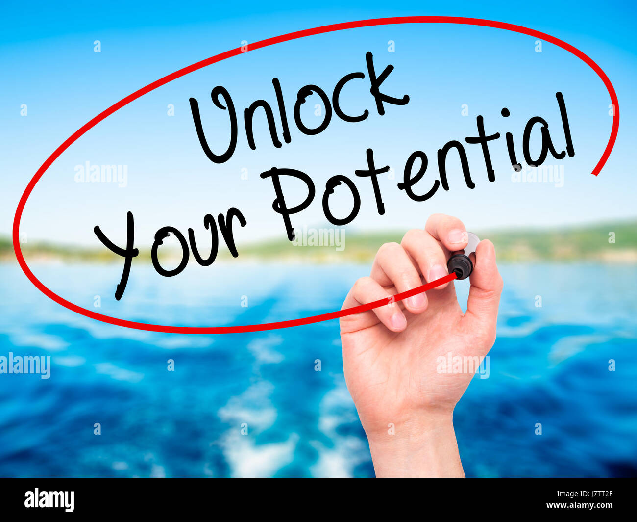 Man Hand writing Unlock Your Potential with black marker on visual ...