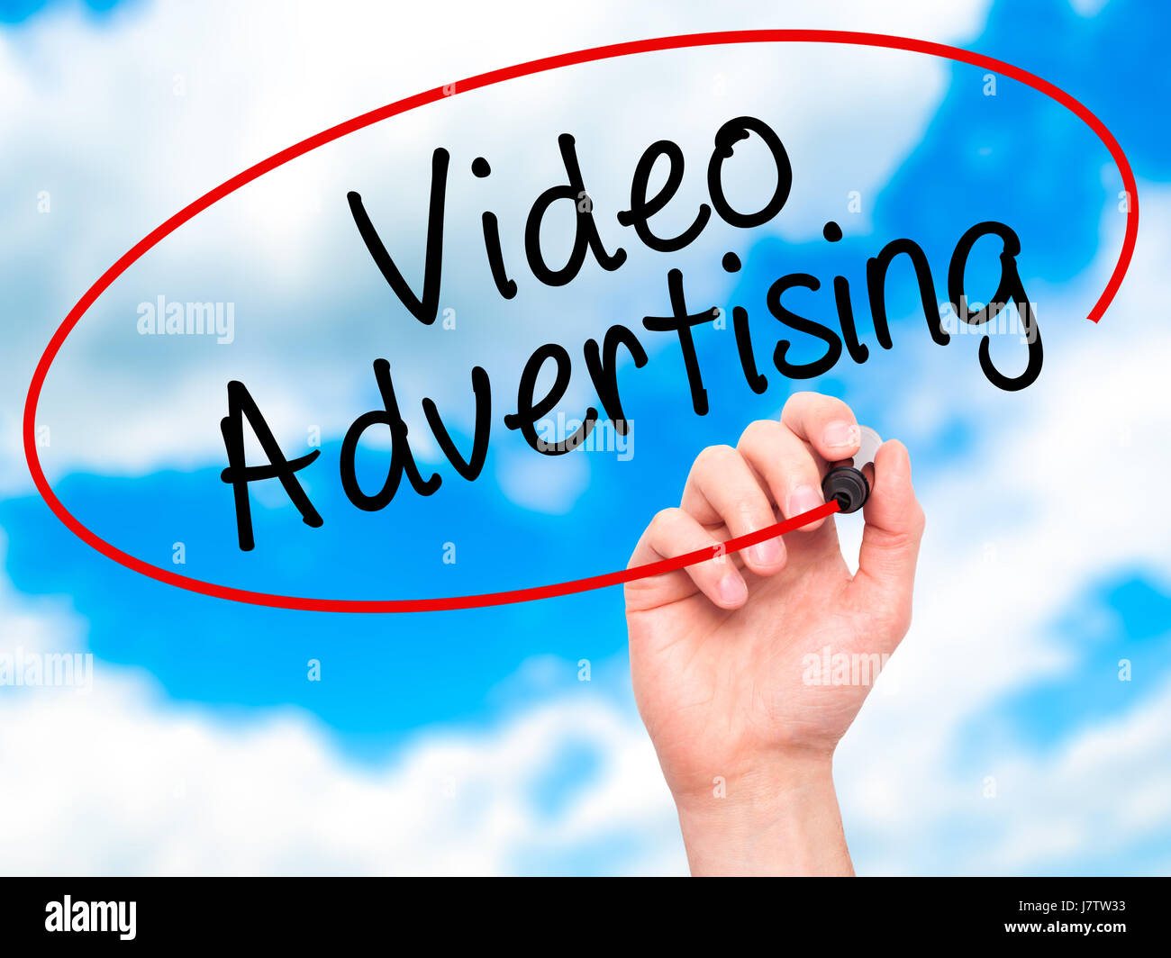 Man Hand writing Video Advertising with black marker on visual screen ...