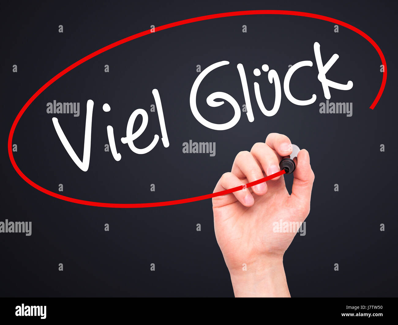Man Hand writing Viel Gluck (Good Luck in German) with black marker on ...