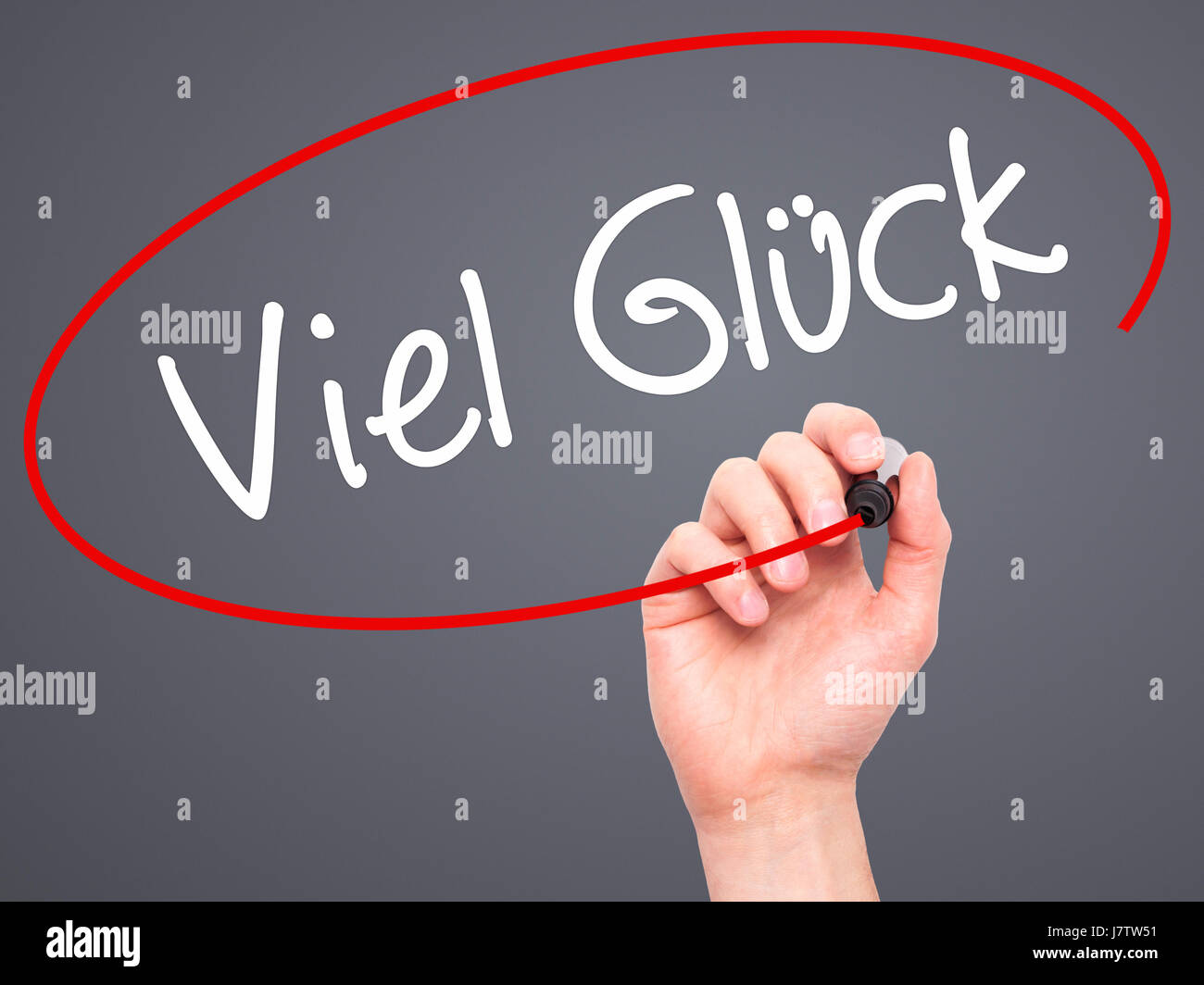 Man Hand writing Viel Gluck (Good Luck in German) with black marker on ...
