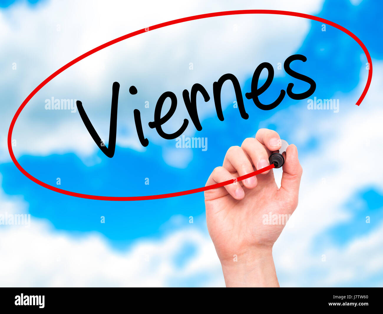 Man Hand writing Viernes (Friday in Spanish) with black marker on ...
