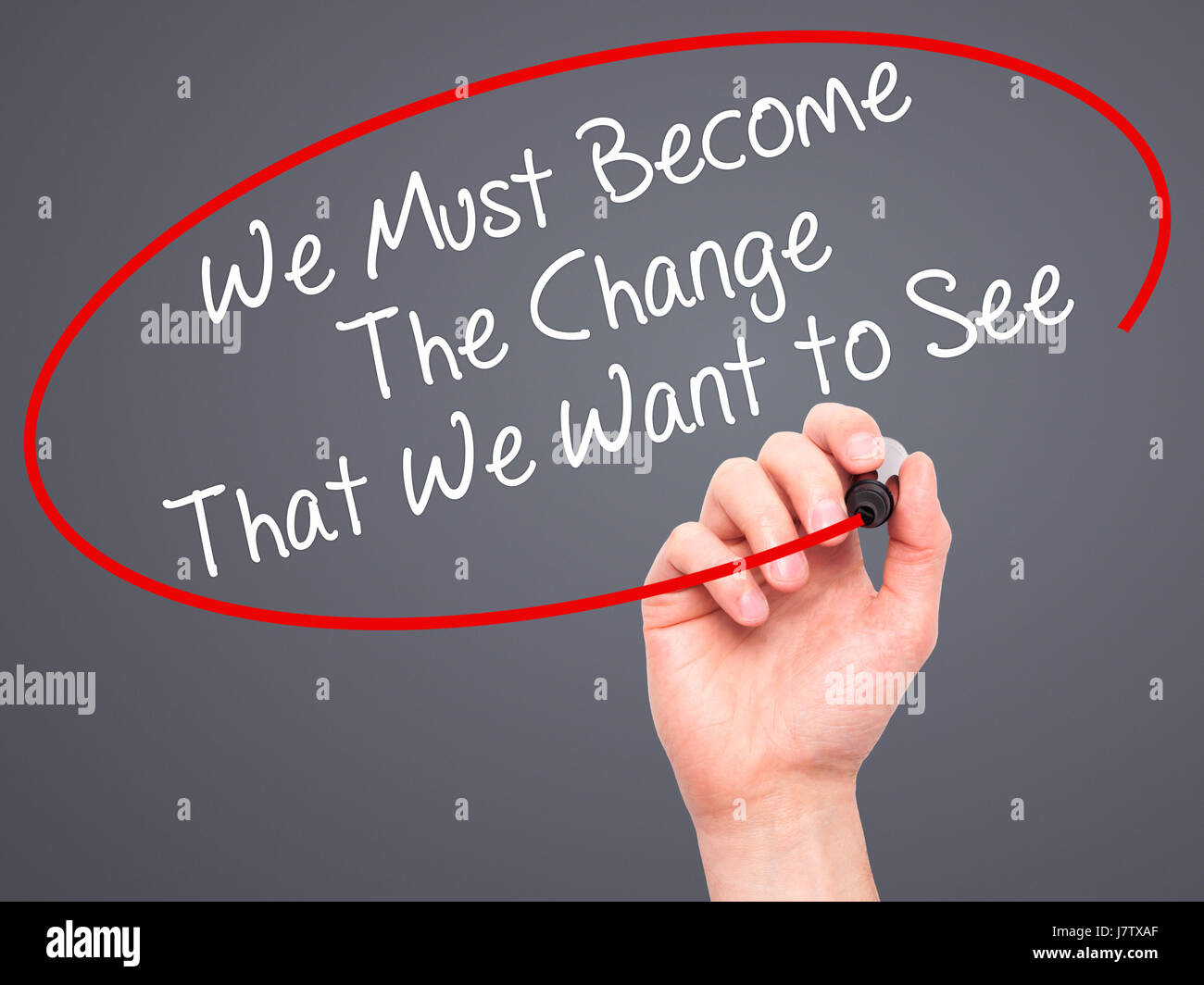 Man Hand writing We Must Become The Change That We Want to See with ...