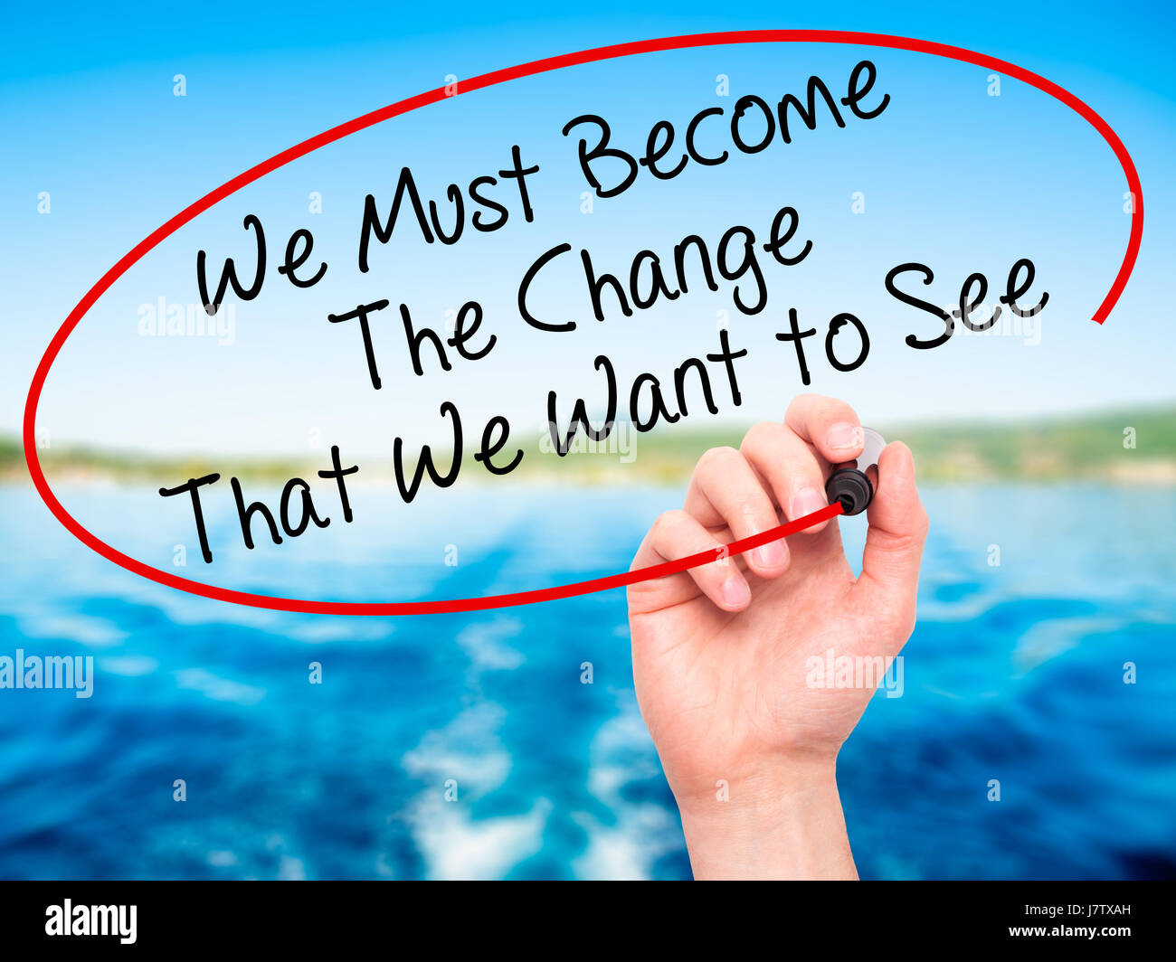 Man Hand writing We Must Become The Change That We Want to See with ...