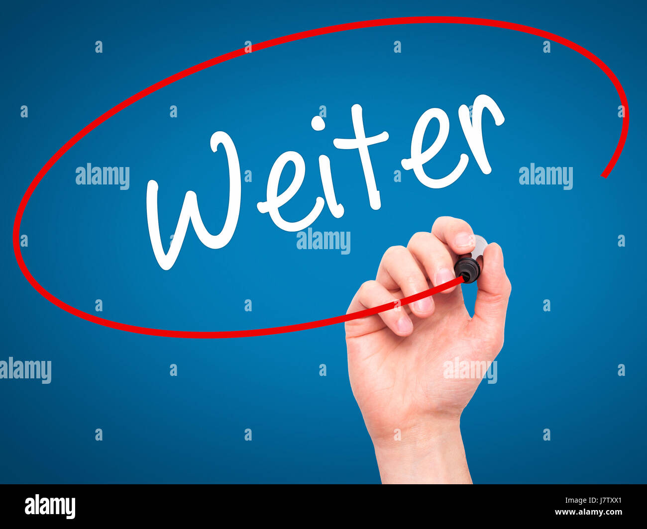 Man Hand writing Weiter (Continue in German) with black marker on ...