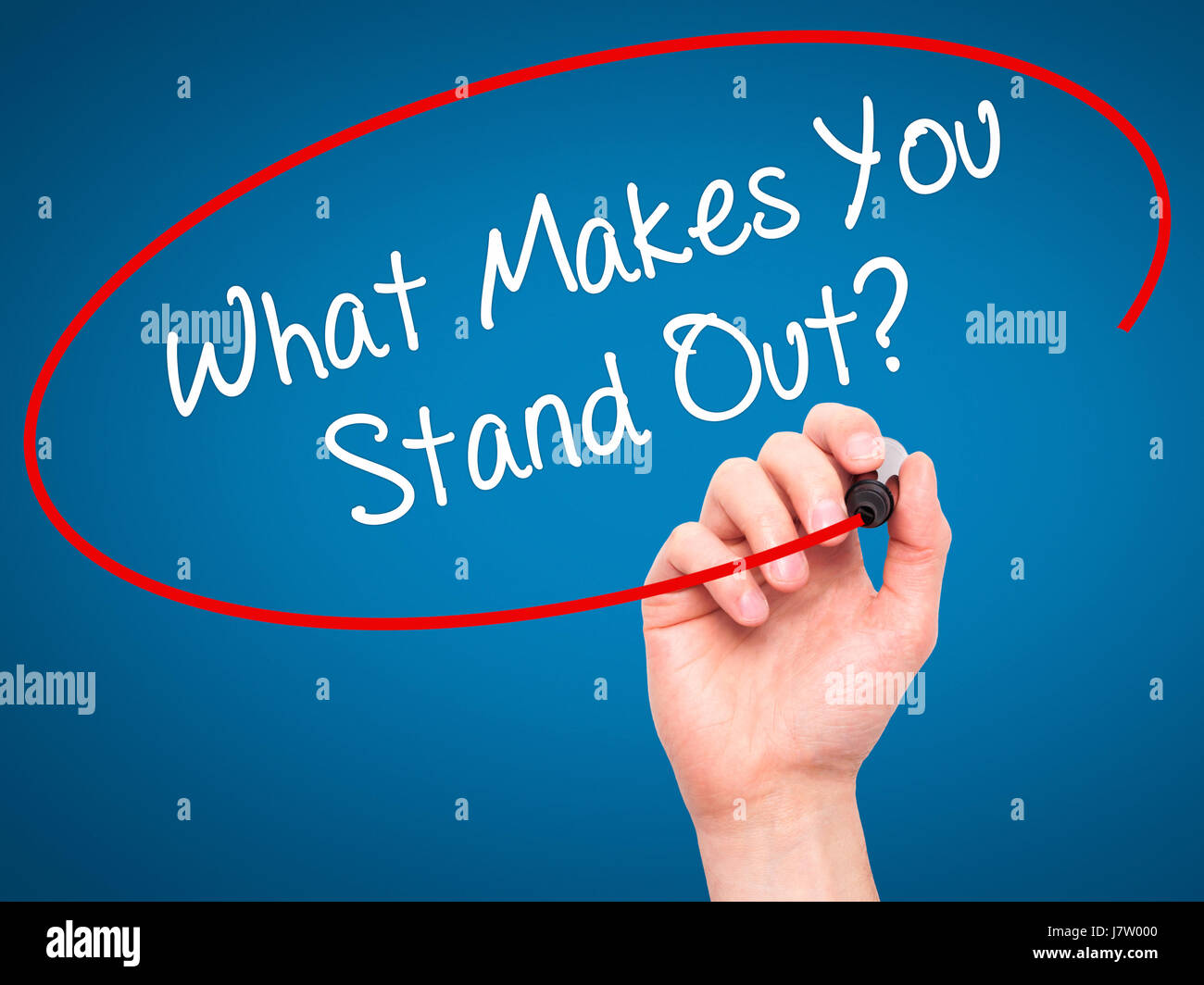 Man Hand writing What Makes You Stand Out? with black marker on visual ...