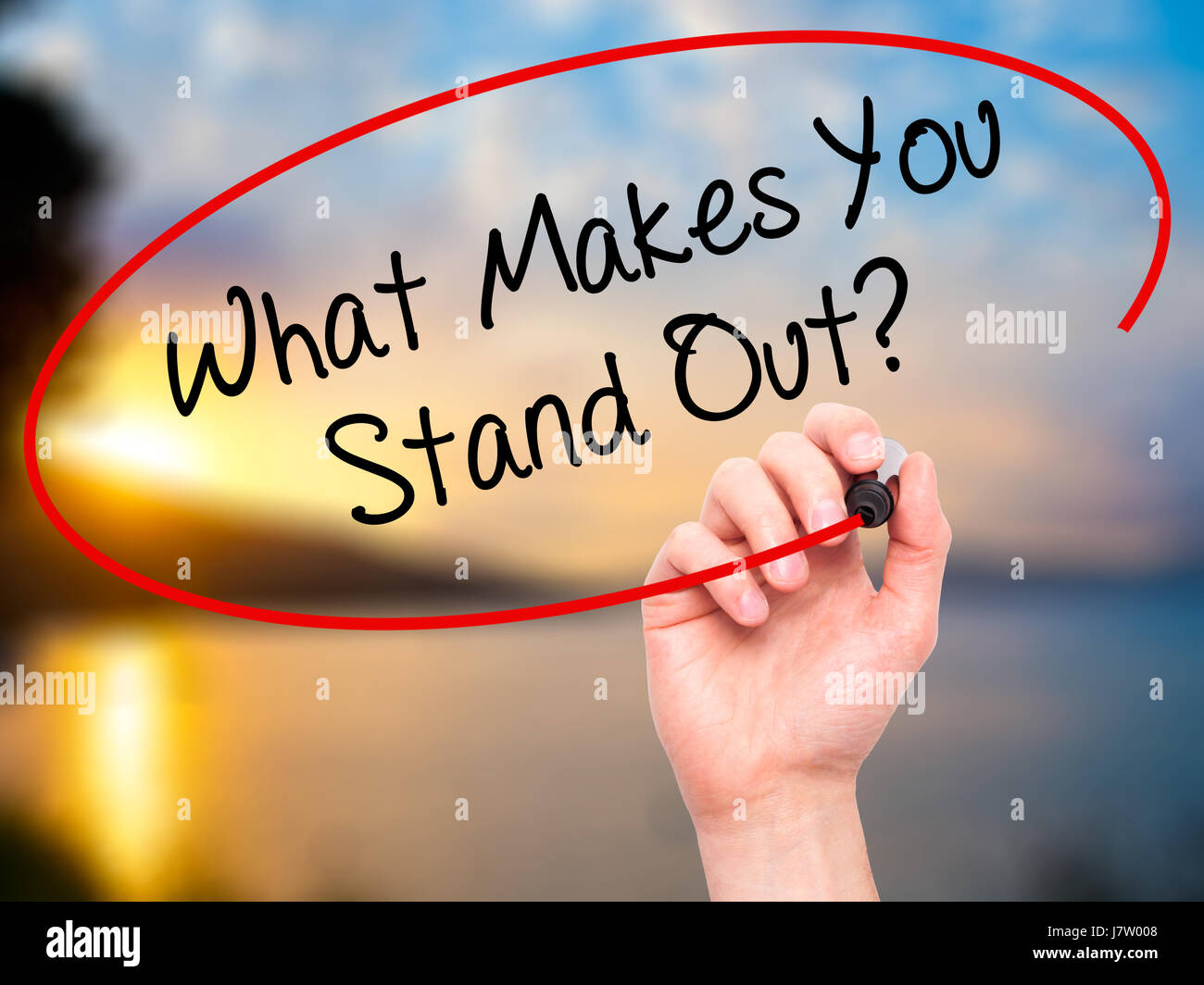 Man Hand writing What Makes You Stand Out? with black marker on visual ...