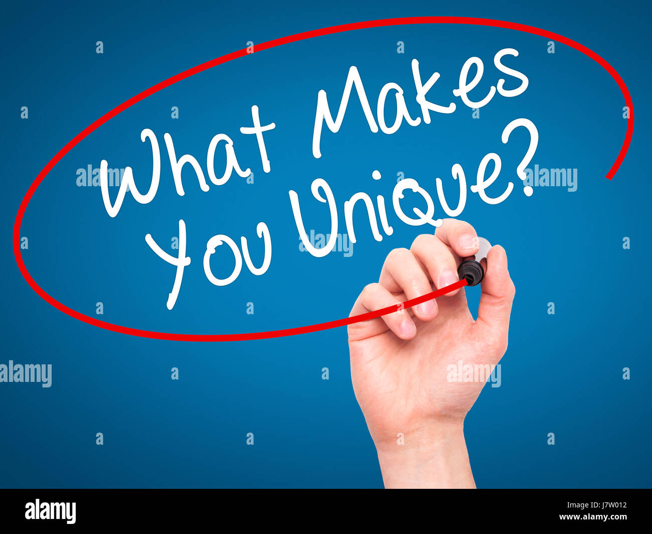 Man Hand writing What Makes You Unique? with black marker on visual ...