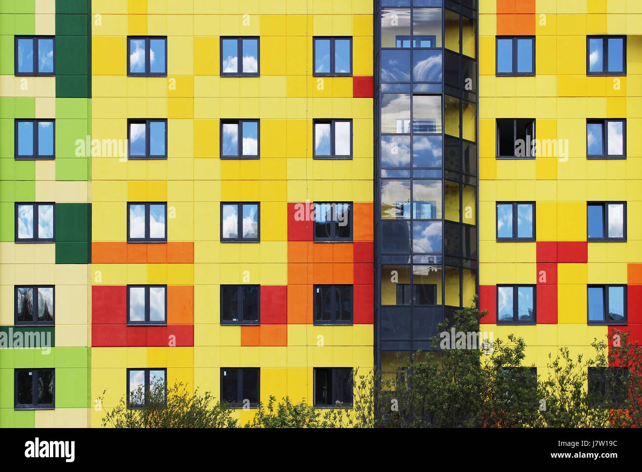 nice colorful yellow and green house a Business center and blue sky ...