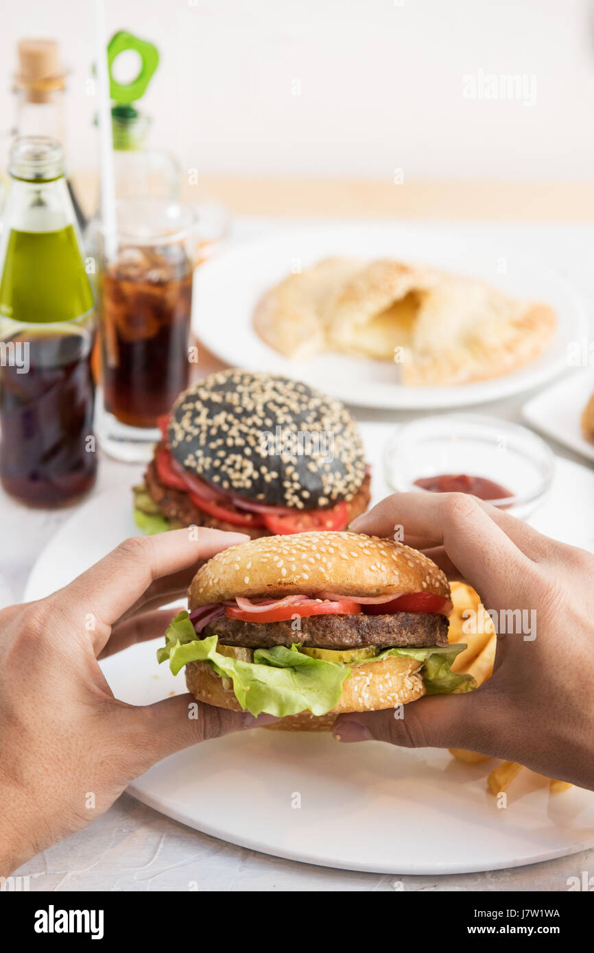 Man eating burgers Stock Photo - Alamy